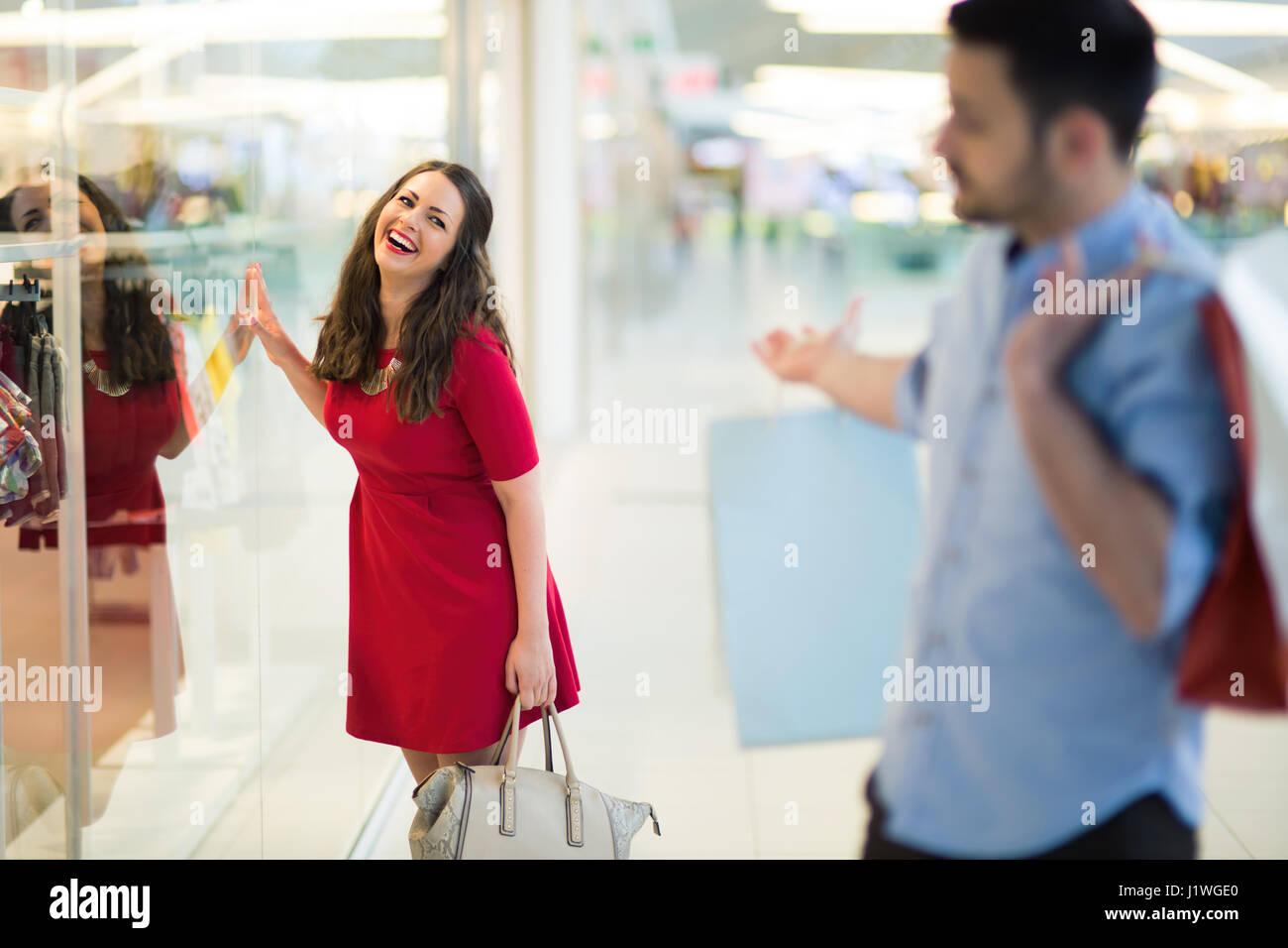 Beautiful couple enjoy shopping together in shopping mall Stock Photo ...