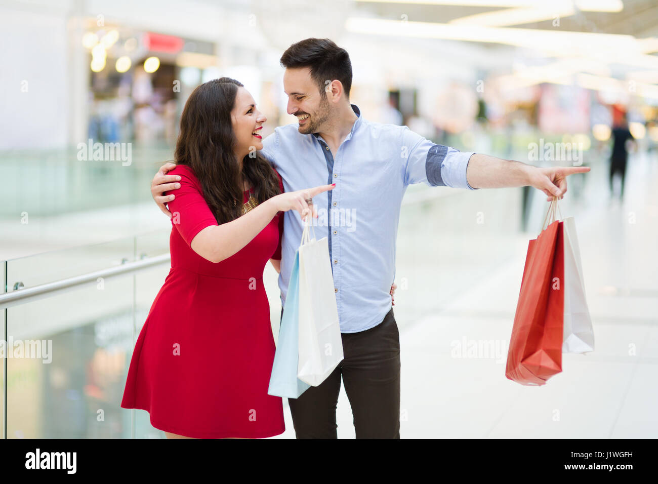 Beautiful couple enjoy shopping together in shopping mall Stock Photo ...