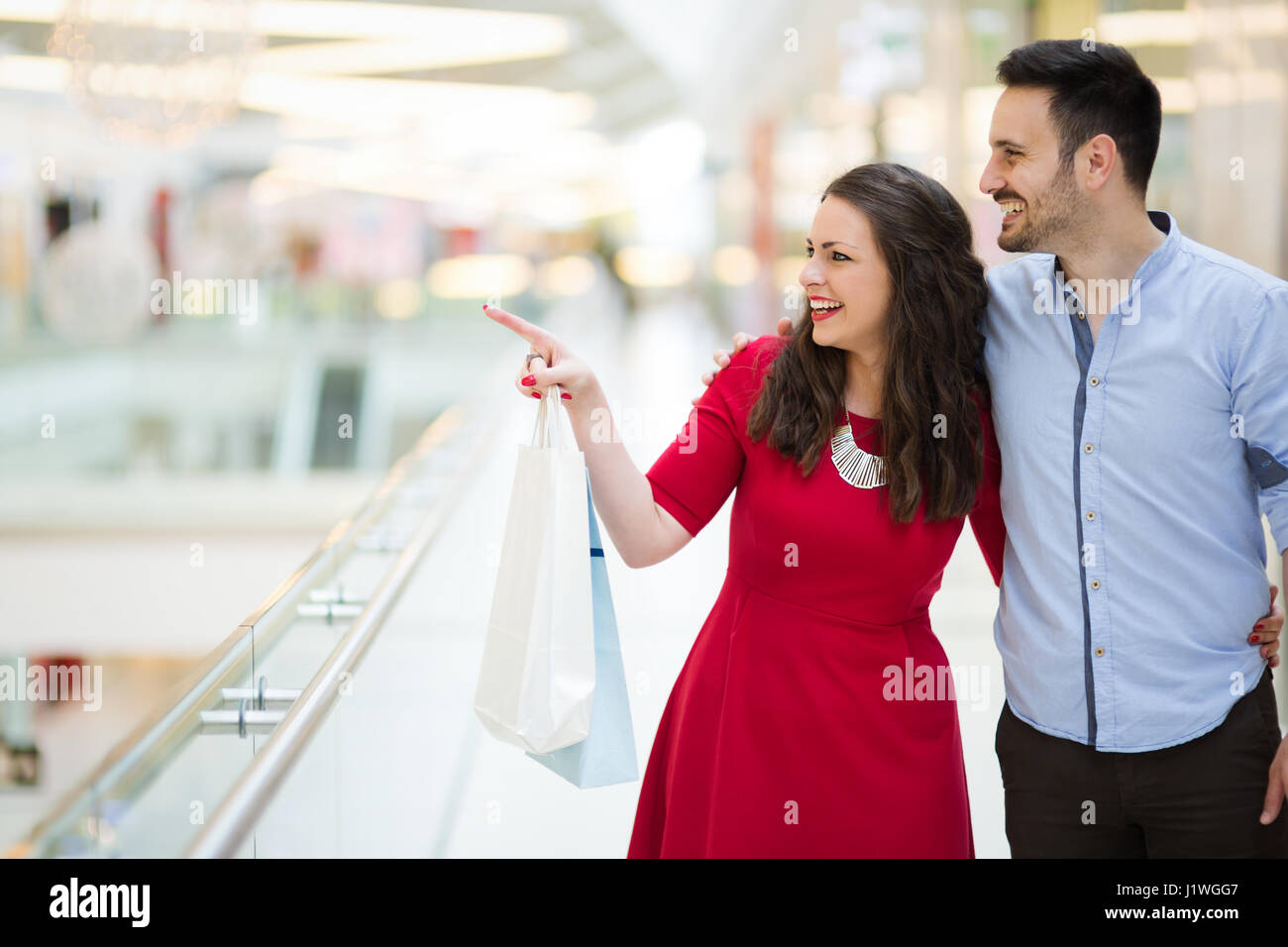 Beautiful couple enjoy shopping together in shopping mall Stock Photo ...