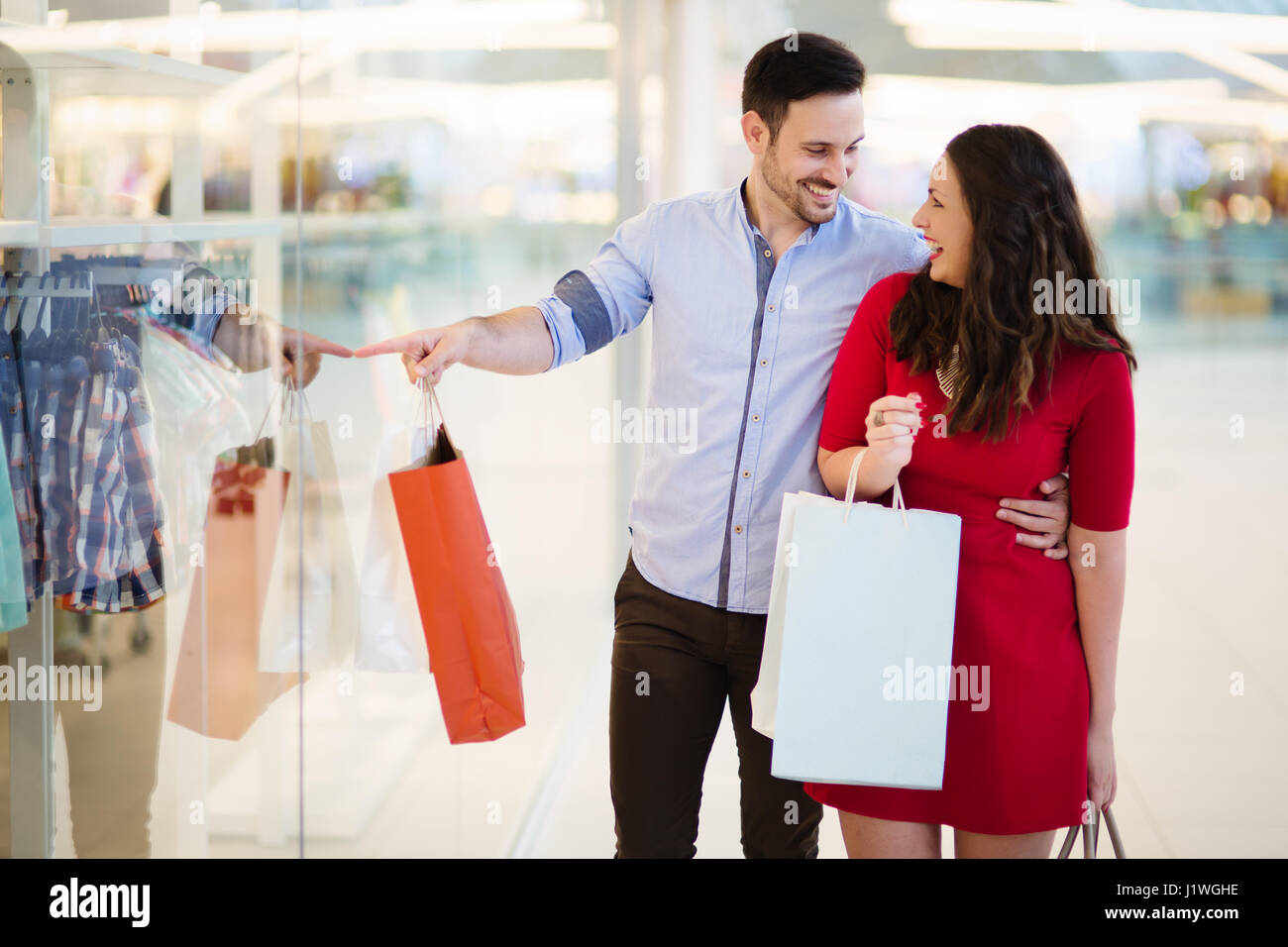 Beautiful couple enjoy shopping together in shopping mall Stock Photo ...