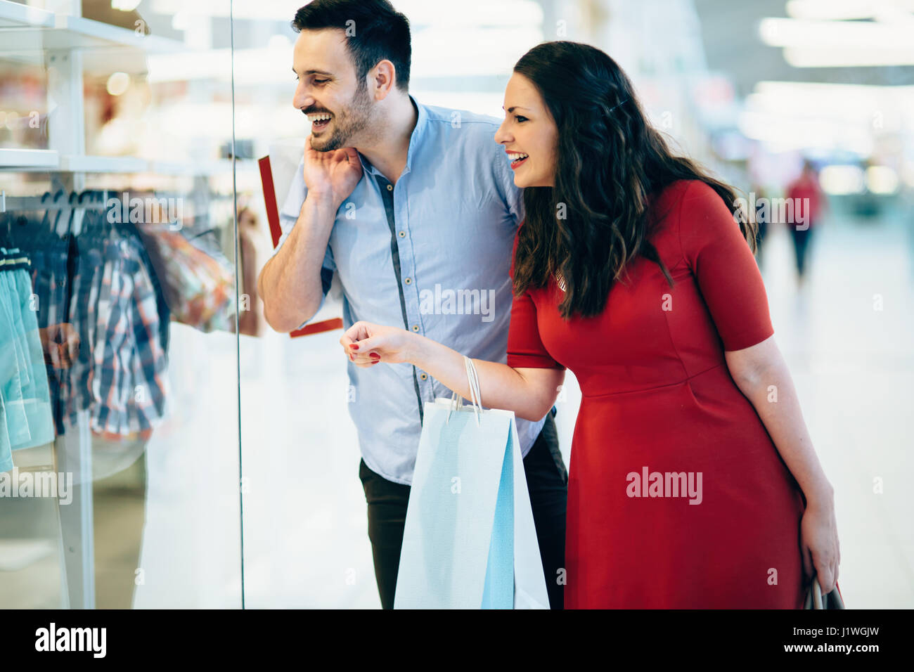 Beautiful couple enjoy shopping together in shopping mall Stock Photo ...