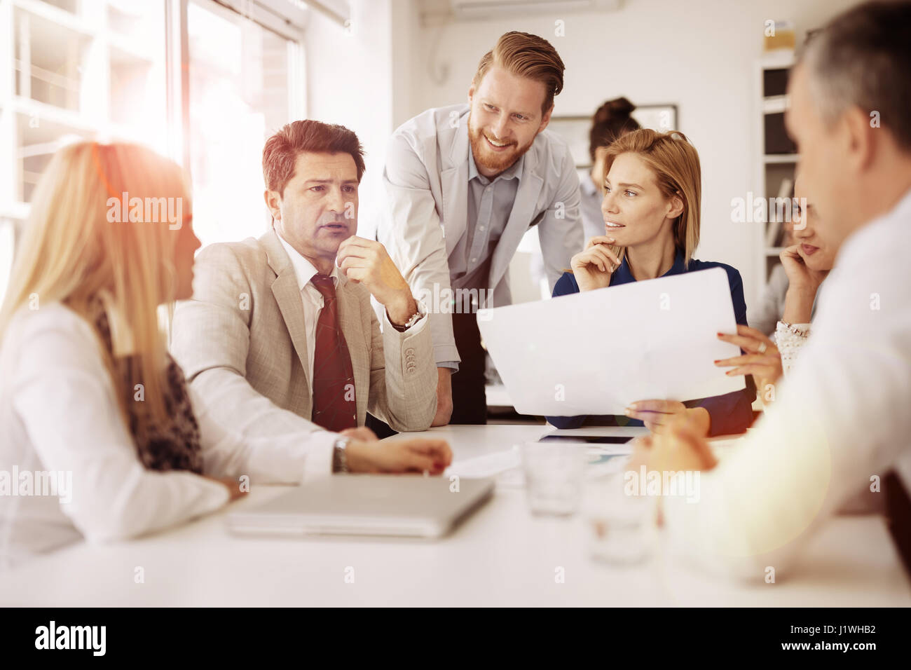 Succeful business partners brainstorming in office Stock Photo - Alamy