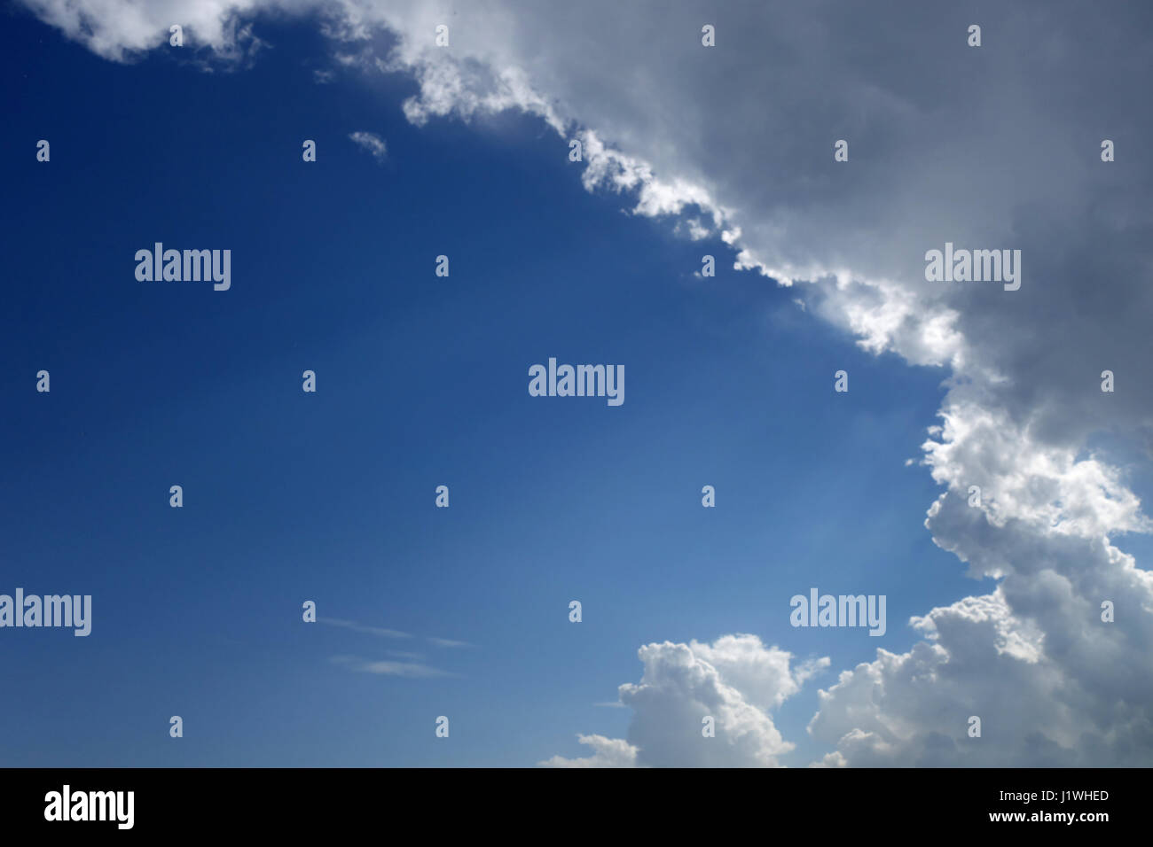 Blue sky with rain clouds and sun Stock Photo - Alamy