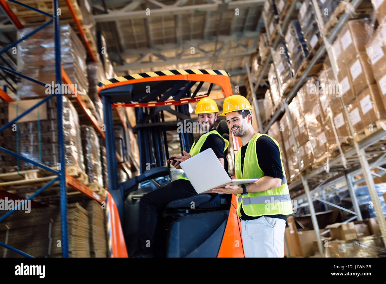 Logistics people working in warehouse Stock Photo - Alamy