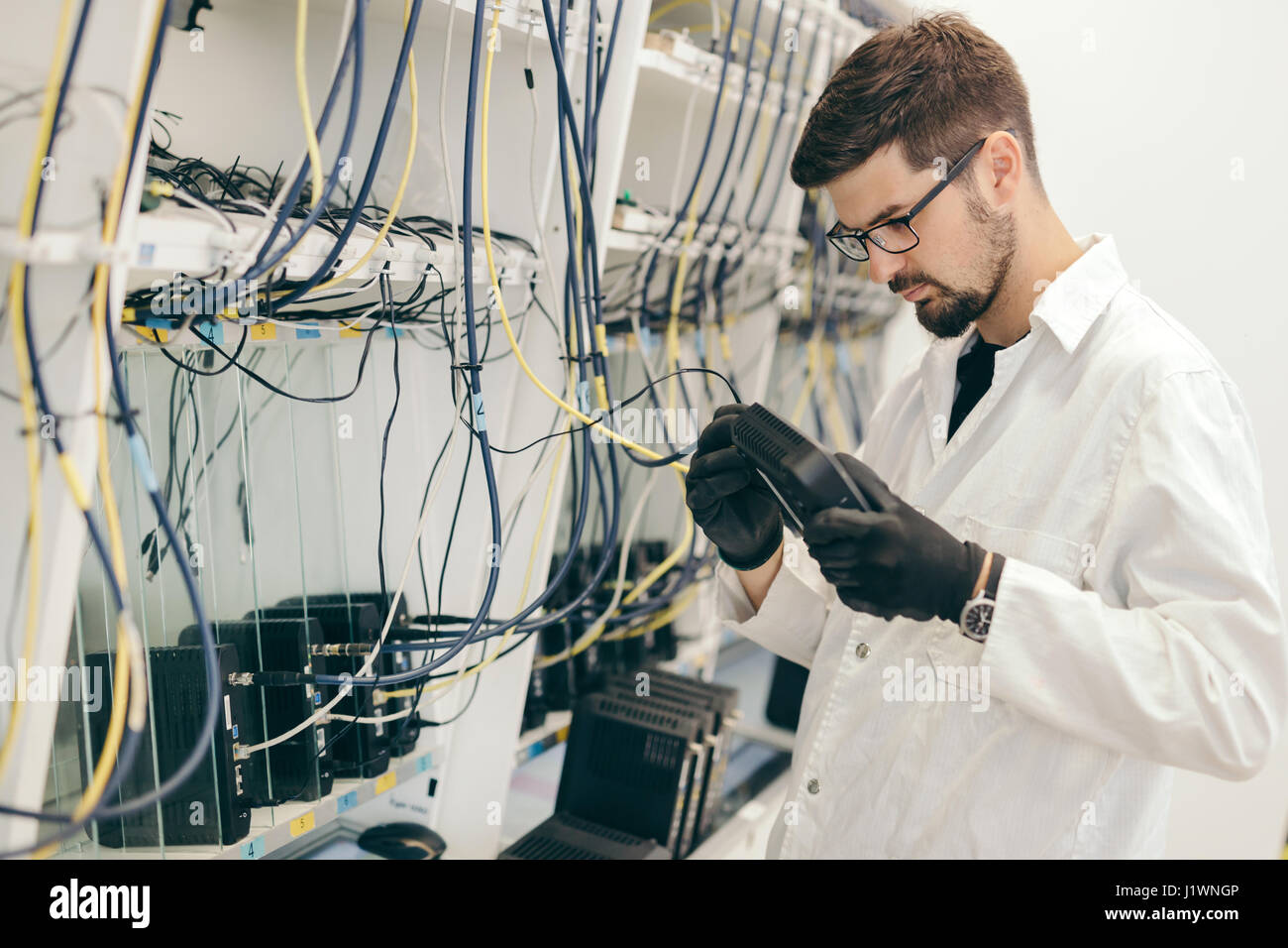 Professional network hardware inspection Stock Photo - Alamy
