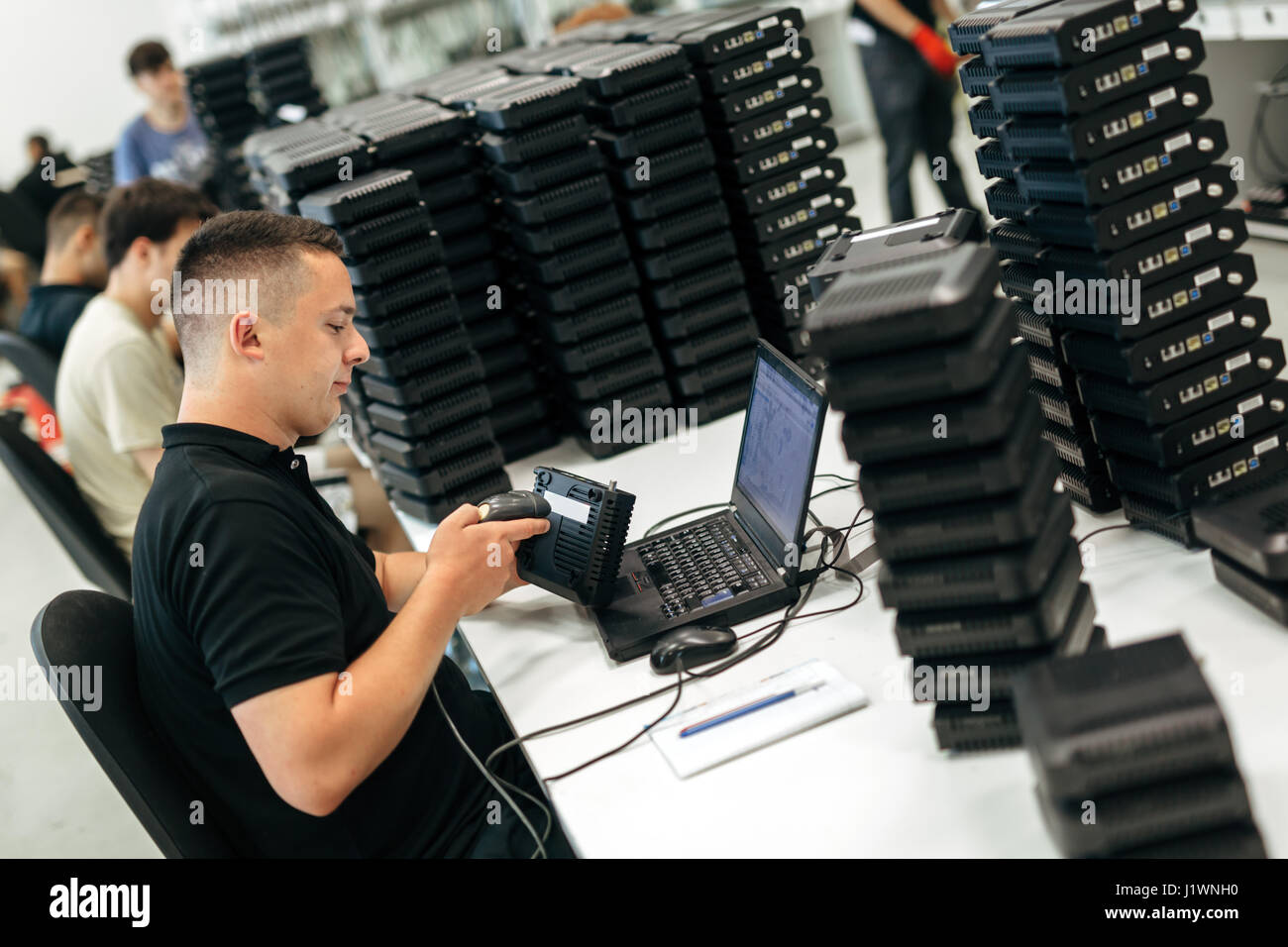 Worker using barcode reader to identify product Stock Photo - Alamy
