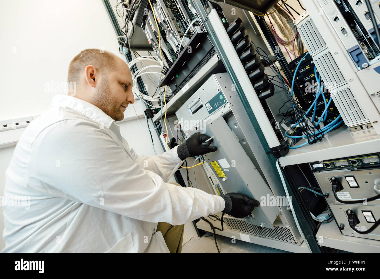 System administrator fixing database hi-res stock photography and ...