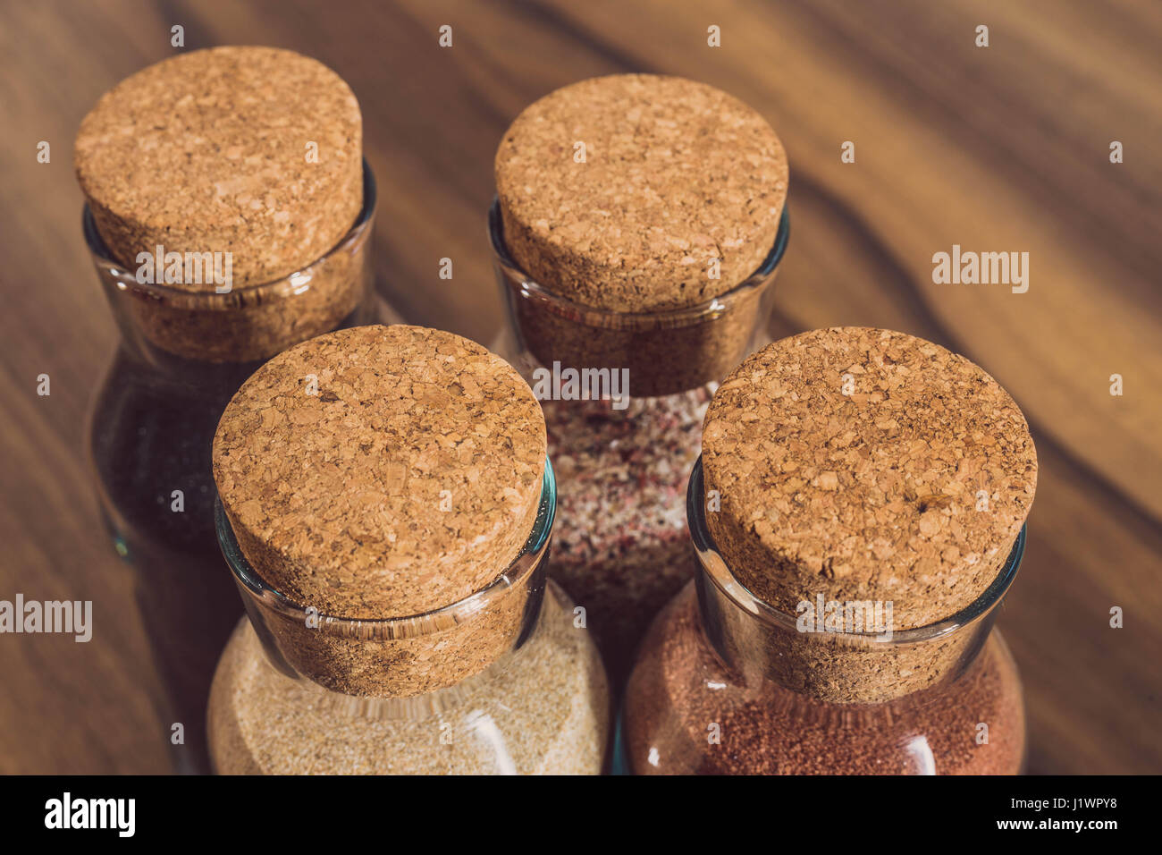 Bottles with colored sand Stock Photo - Alamy
