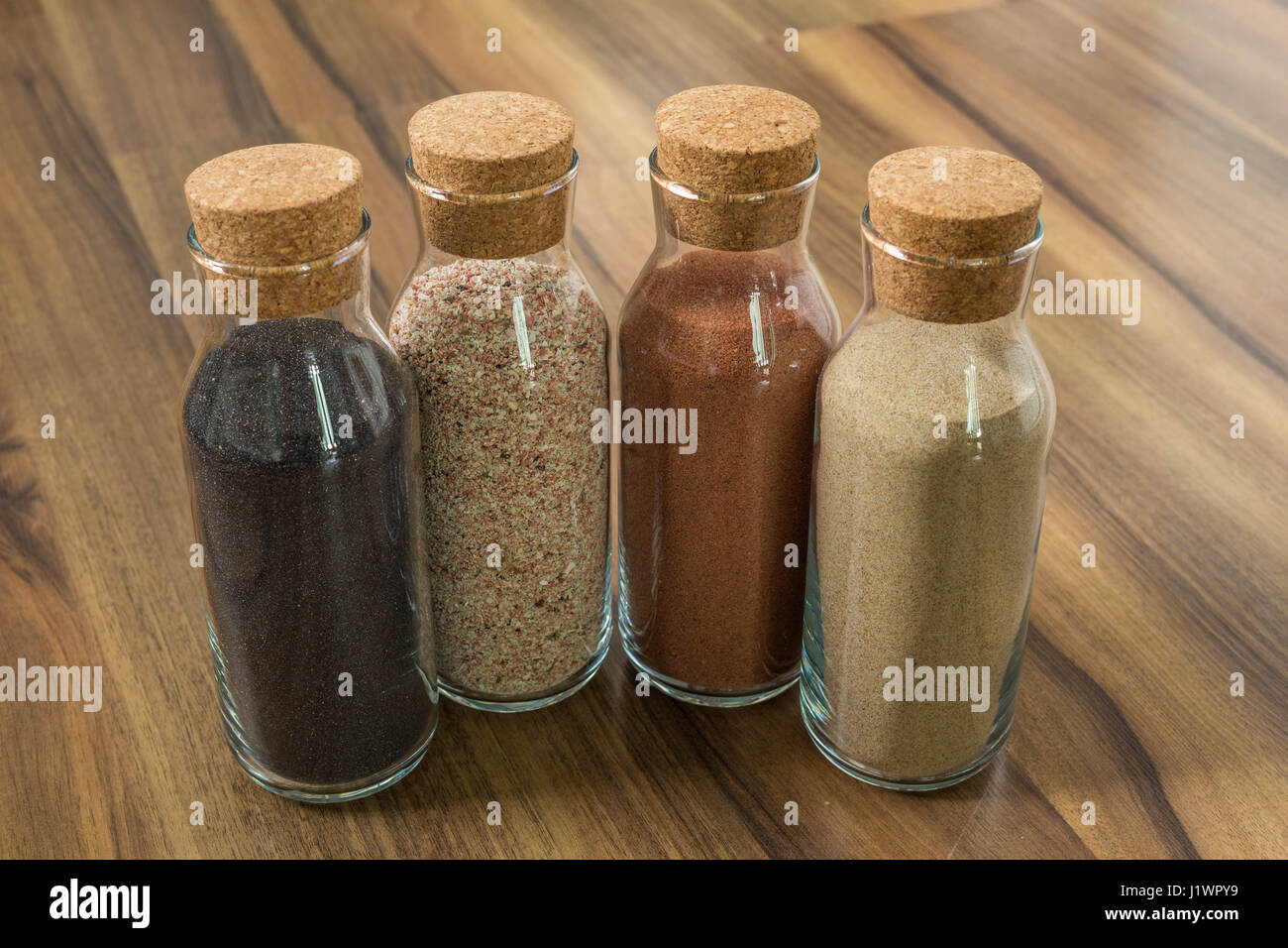 Bottles with colored sand Stock Photo - Alamy