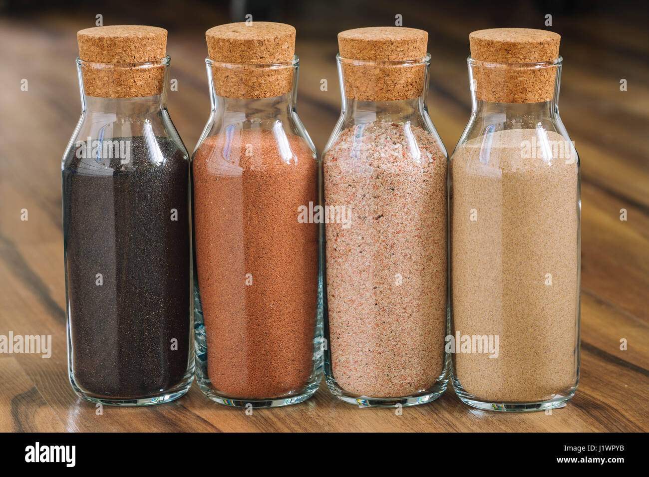 Bottles with colored sand Stock Photo - Alamy