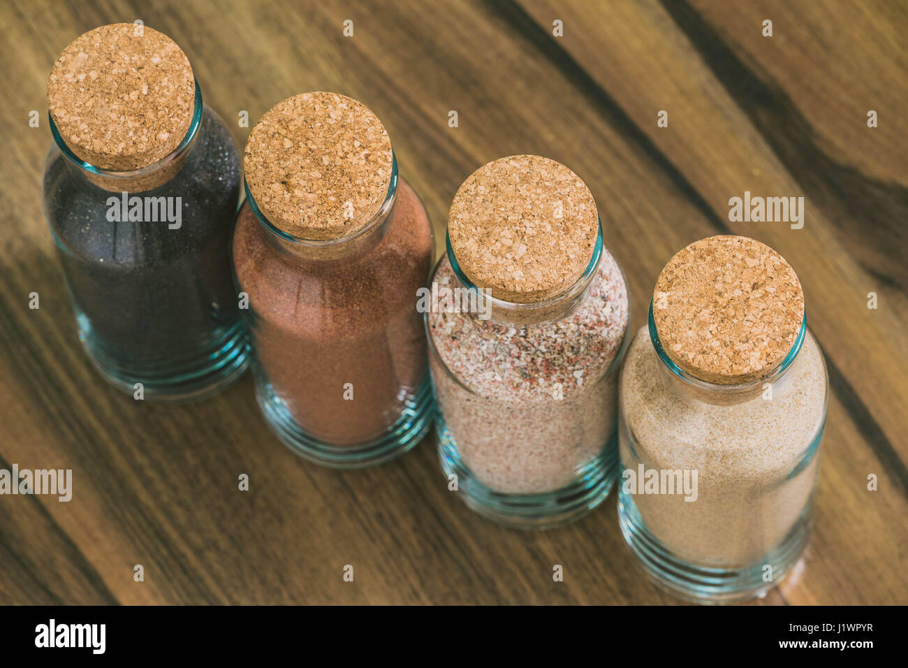 Bottles with colored sand Stock Photo - Alamy