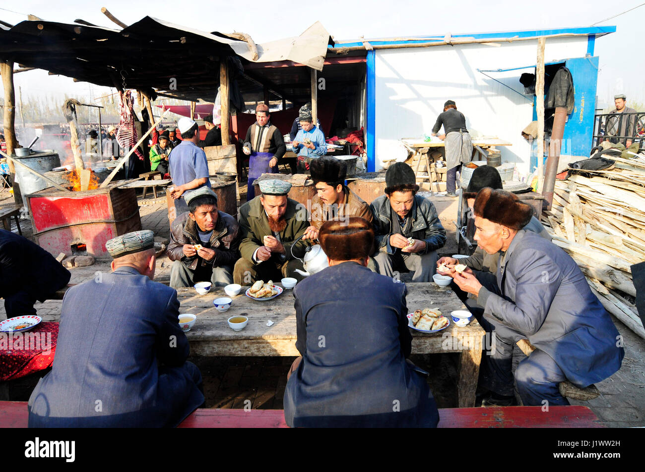 Uyghur men enjoying a cup of tea in a traditional tea house in Kashgar ...