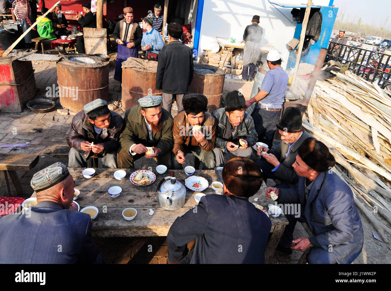 Uyghur men enjoying a cup of tea in a traditional tea house in Kashgar ...