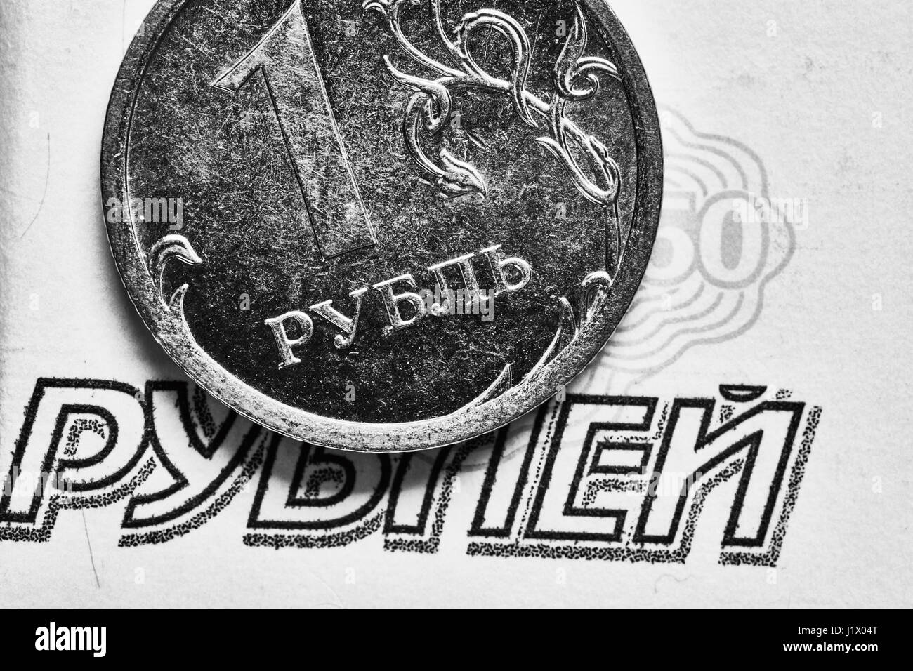 Rubl coin macro with note on background Stock Photo - Alamy