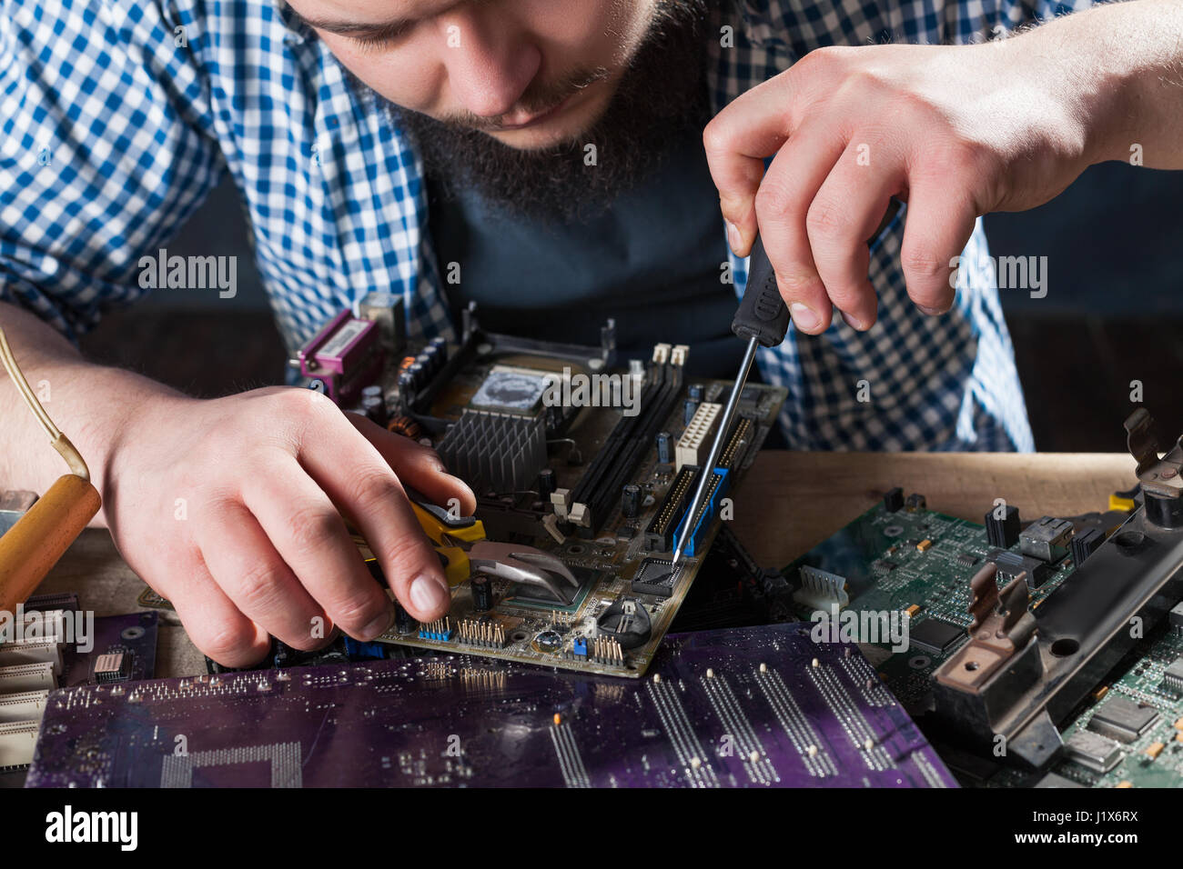 Male service engineer disassembling laptop with screwdriver. Electronic ...