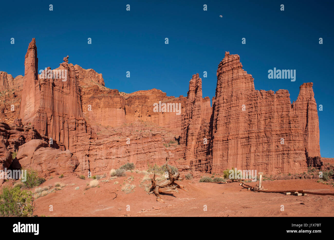 The moon rises above Fisher Towers near Moab, Utah as a sign marks the ...