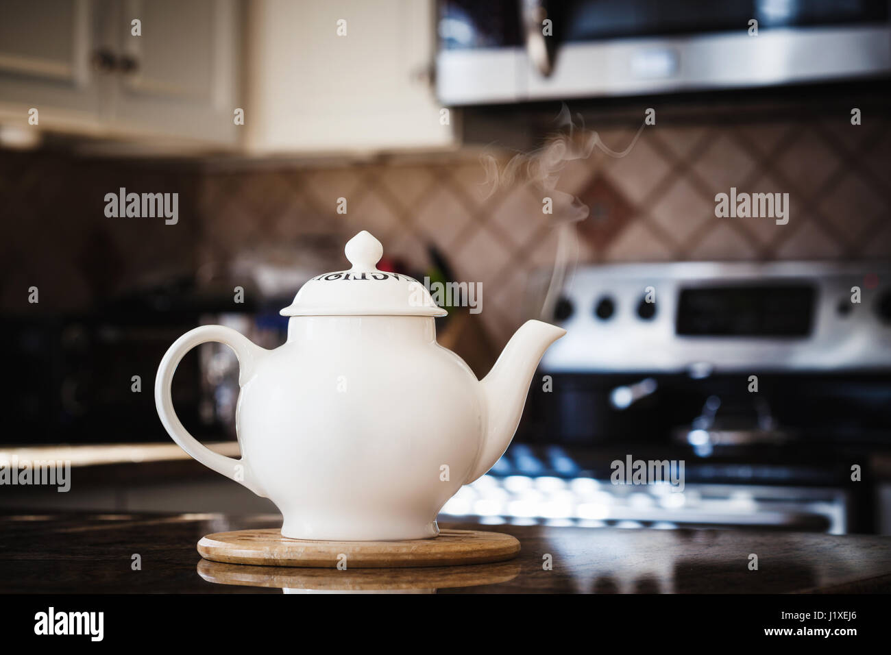 Old style teapot at modern kitchen interior Stock Photo - Alamy