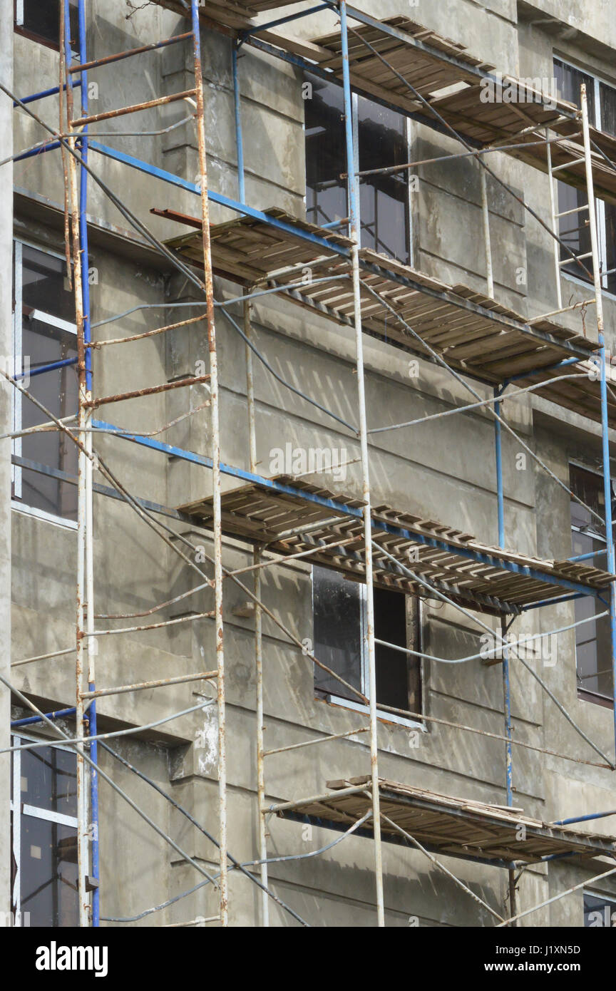 Naked concrete wall without cladding in a new house with new windows ...