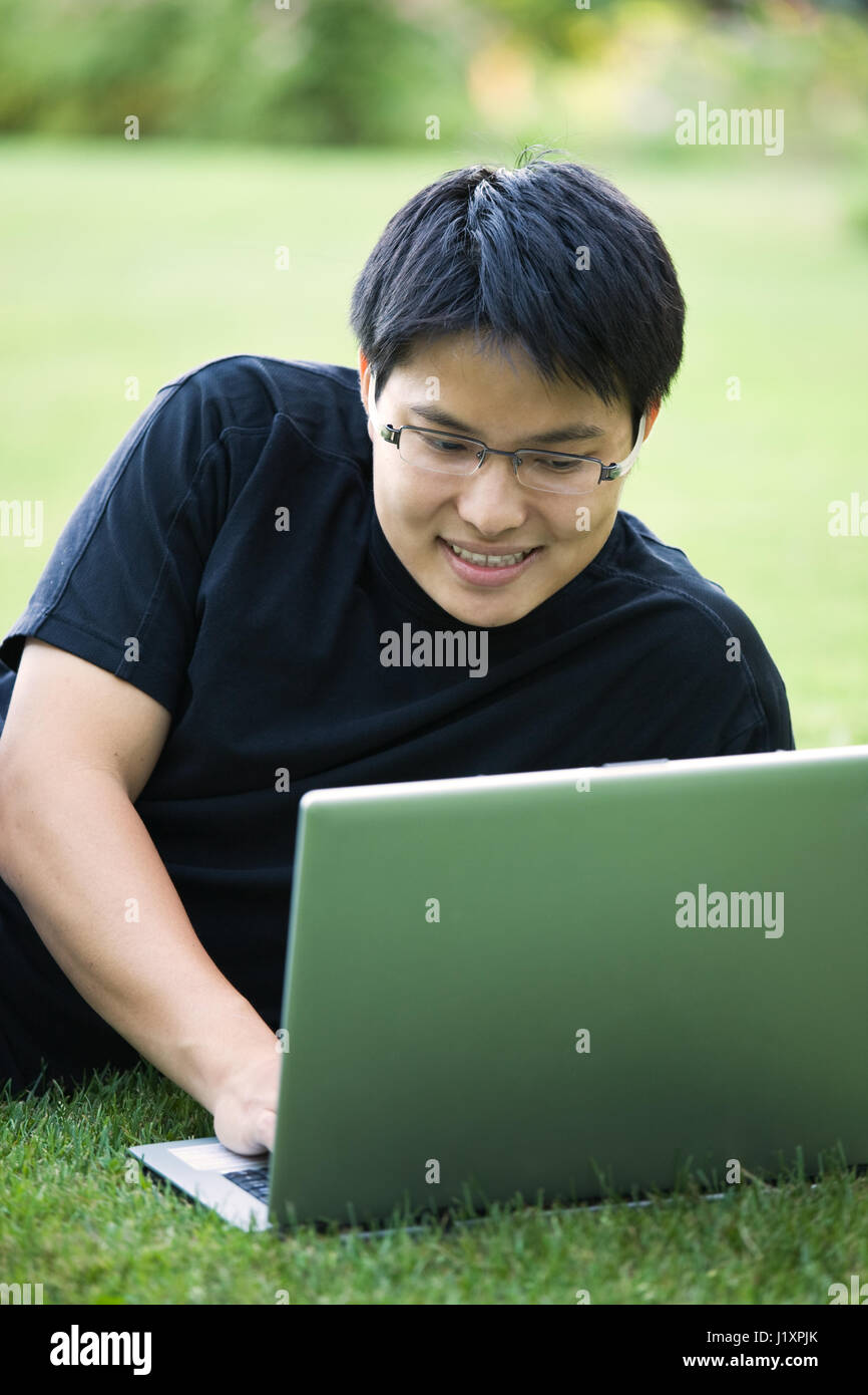 An asian college student working on his laptop outdoor Stock Photo - Alamy