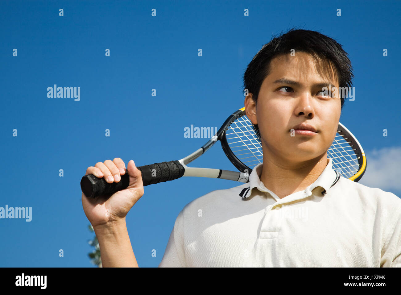 A sporty young asian male playing tennis Stock Photo - Alamy