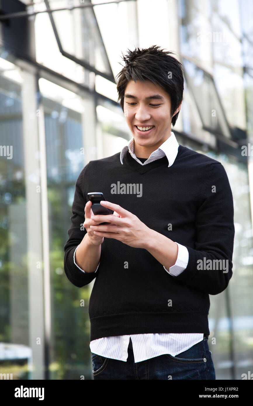 An asian man texting on the cellphone Stock Photo - Alamy