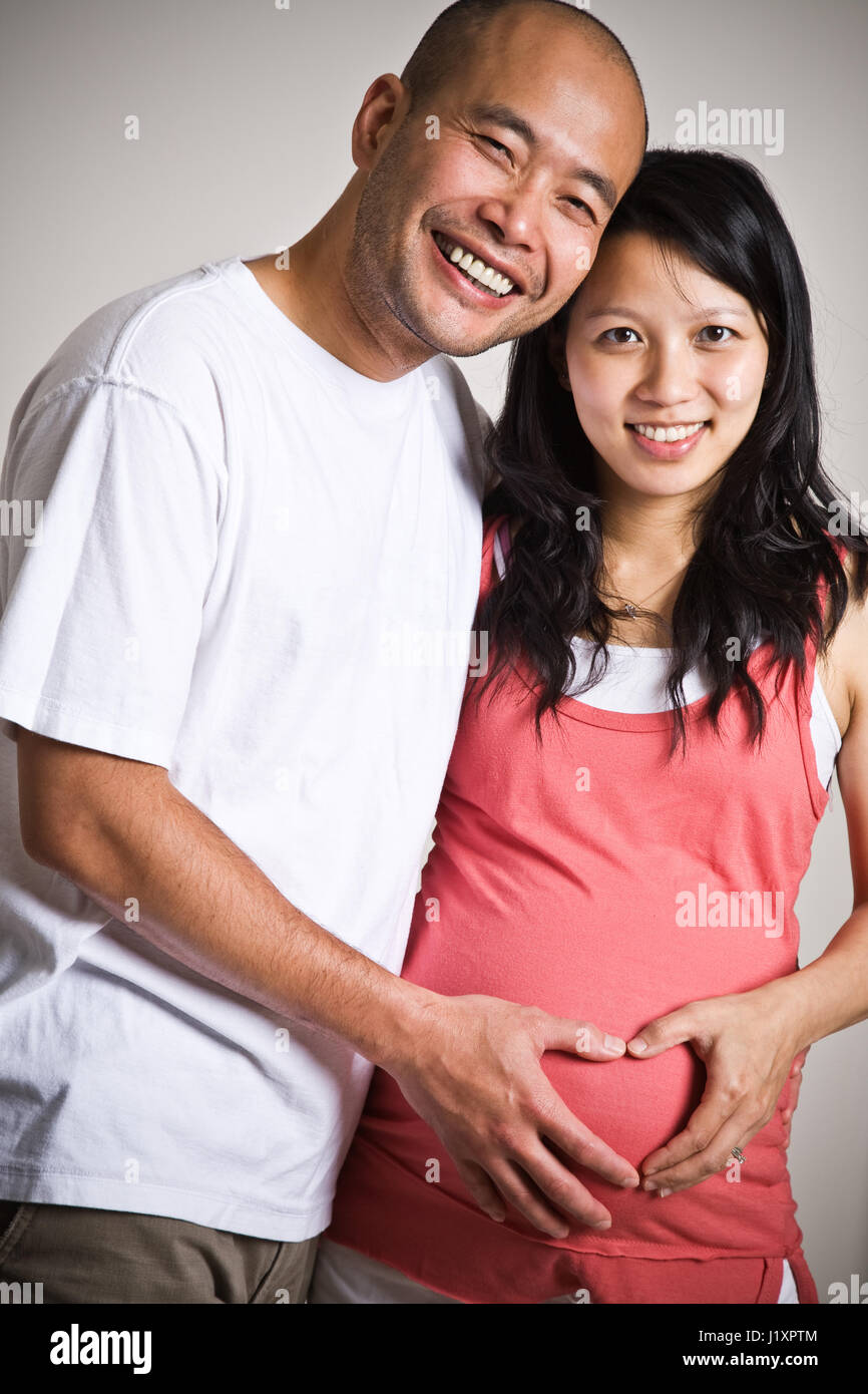 A happy pregnant asian couple expecting their baby Stock Photo - Alamy