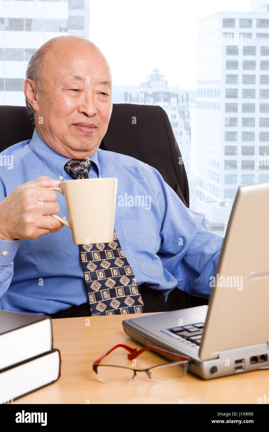 A senior asian businessman working in the office Stock Photo - Alamy