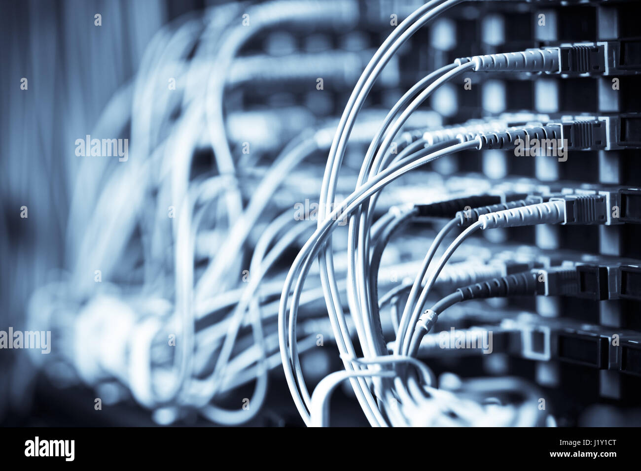 A shot of network cables connected to routers in a data center Stock ...