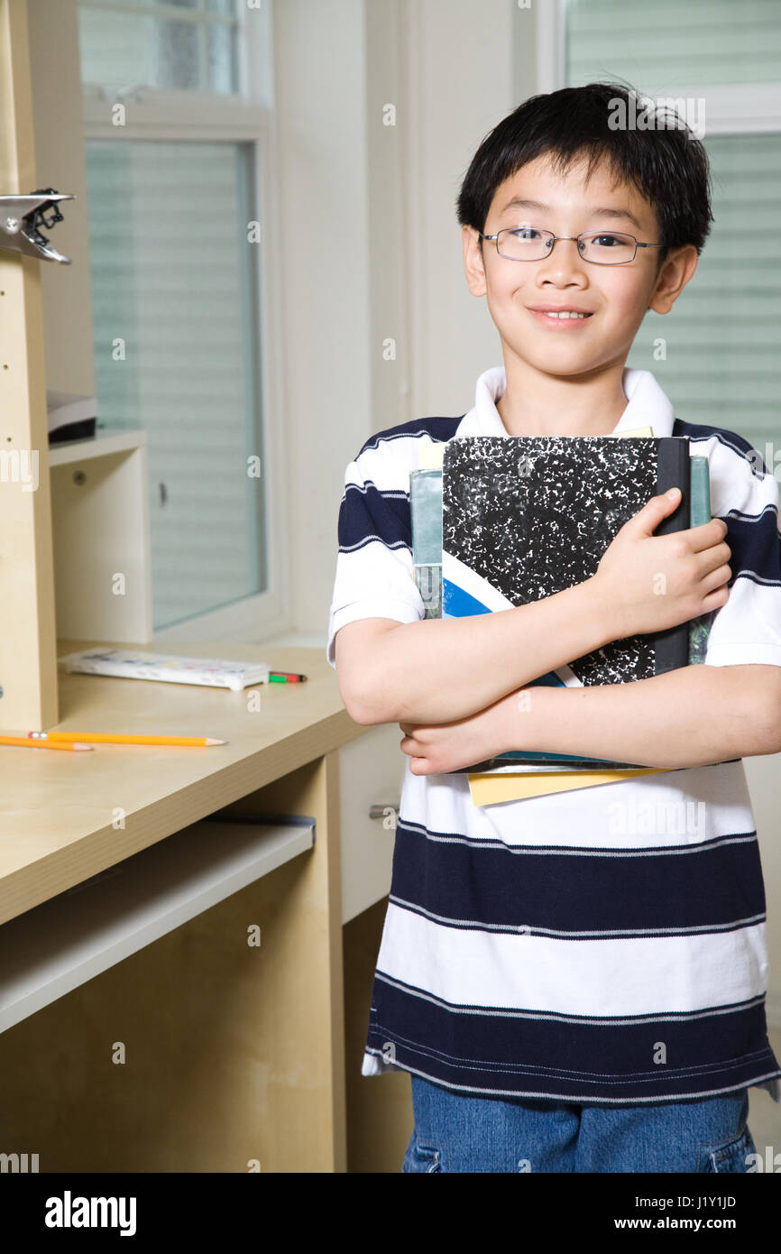 A shot of an asian kid studying at home Stock Photo - Alamy
