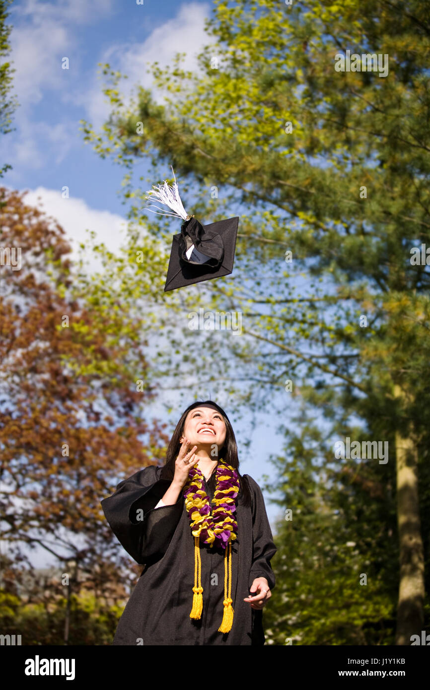 A happy beautiful graduation girl throwing her cap in the air Stock ...