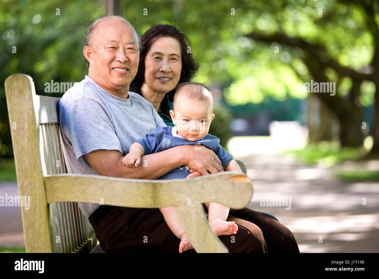 A shot of a cute asian child with his grandparents in a park Stock ...