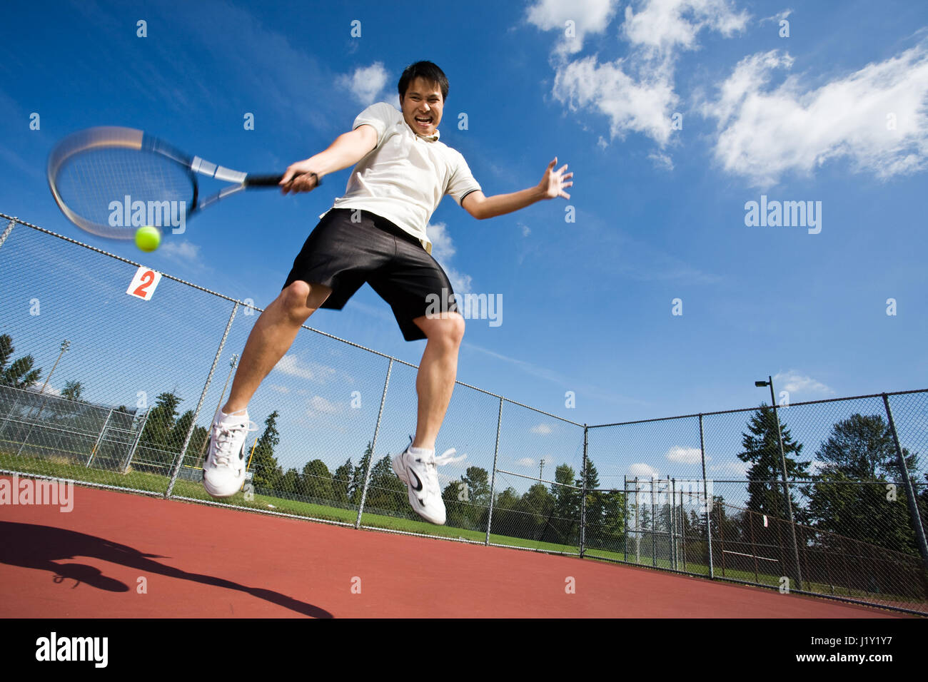 Holding hitting jumping ball hi-res stock photography and images - Alamy