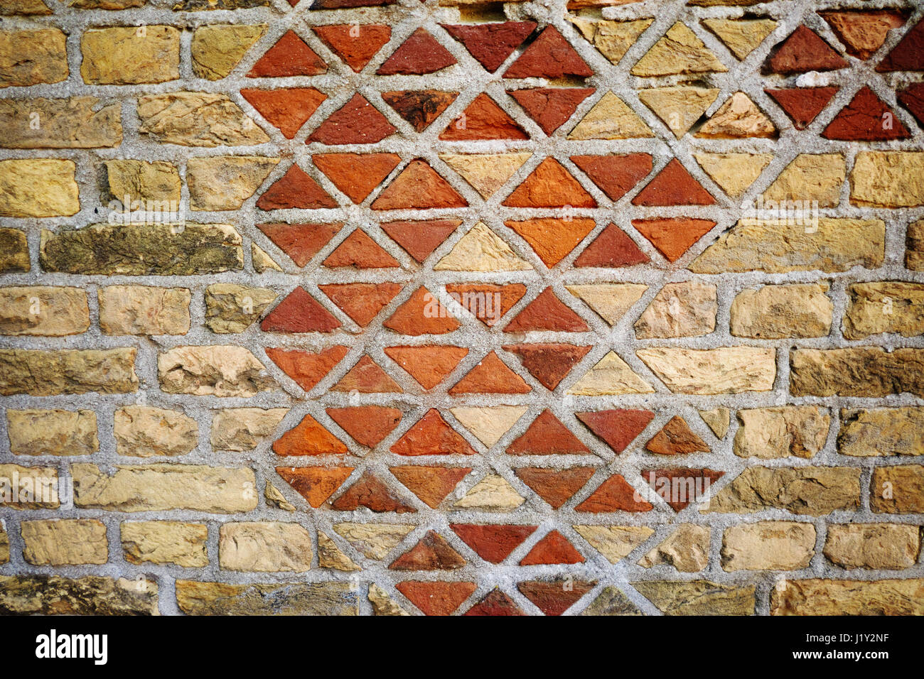 Abstract texture background of old triangle brick wall red and yellow ...