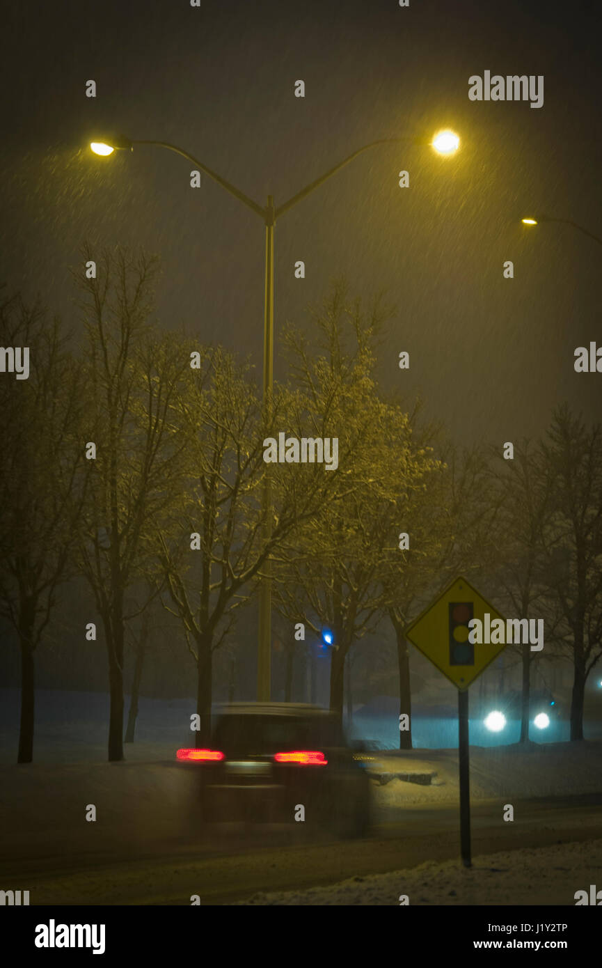 Snow falling on a deserted street at night in Toronto suburbs Stock ...