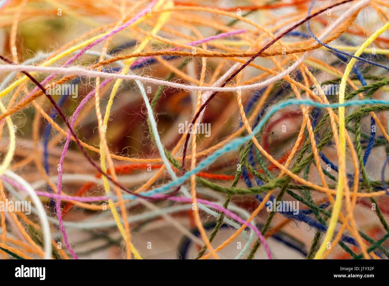 Multi-colored tangled colorful needlecraft silk thread rope. Macro shot ...