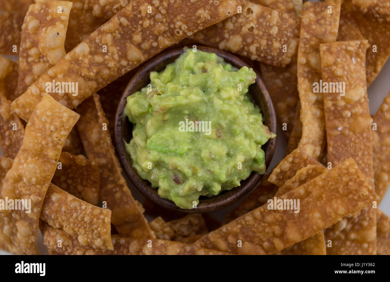 Small Bowl of Guacamole Surrounded by Homemade Chip Strips Stock Photo ...