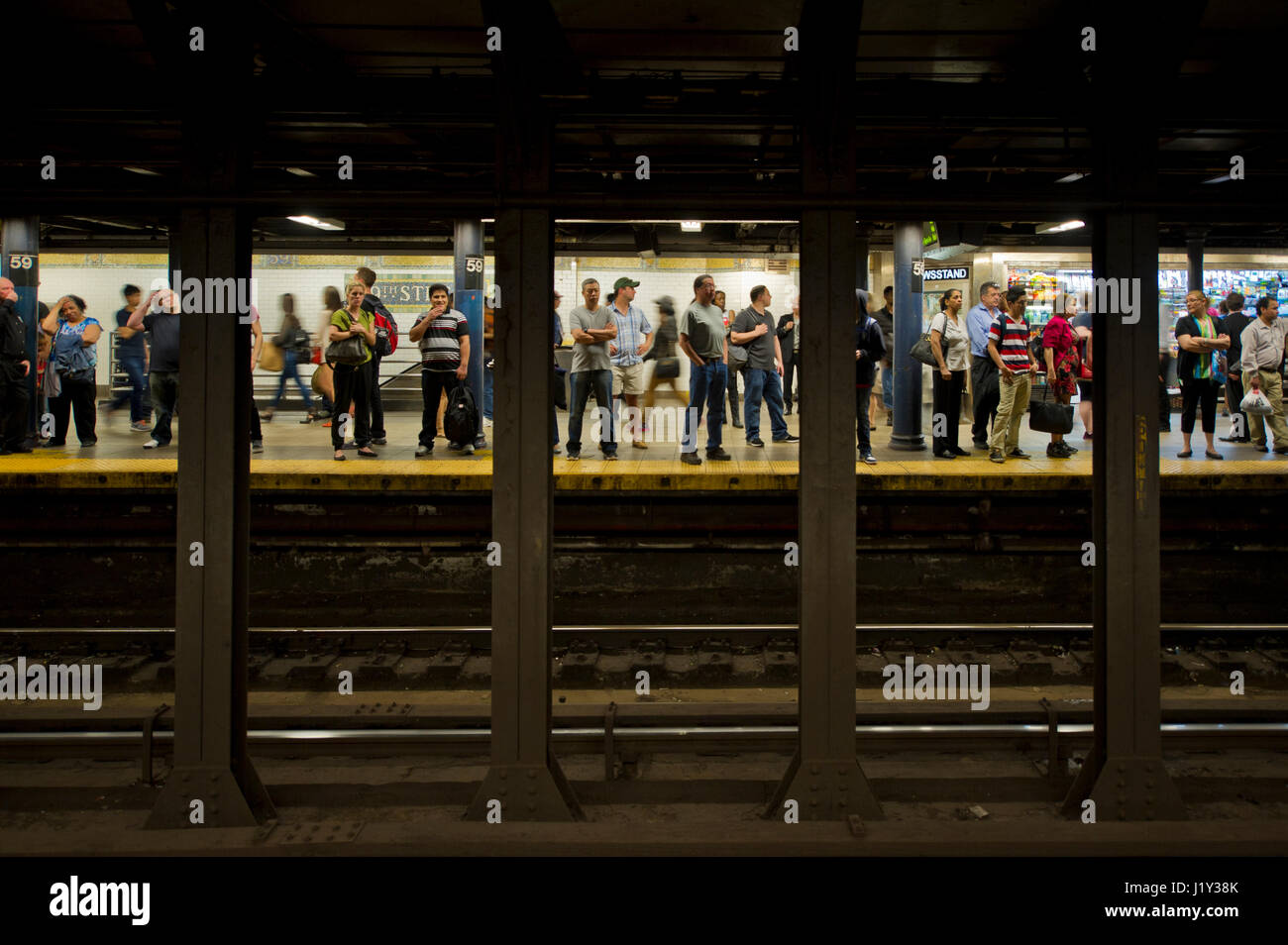 Passengers waiting for a subway train on a platform Stock Photo - Alamy