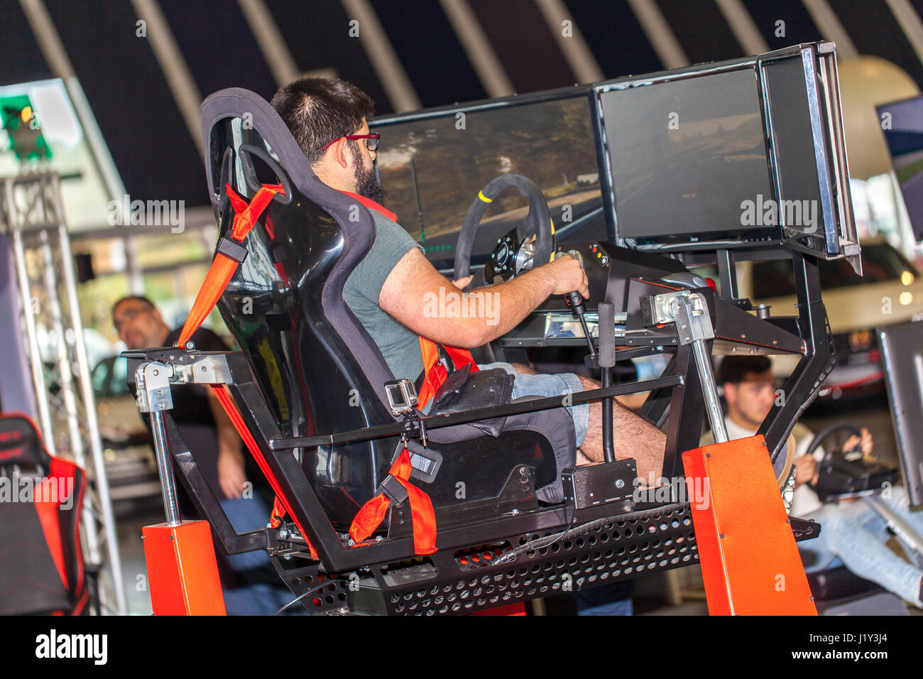 Young man playing car video games sitting on a Playseat Stock Photo - Alamy
