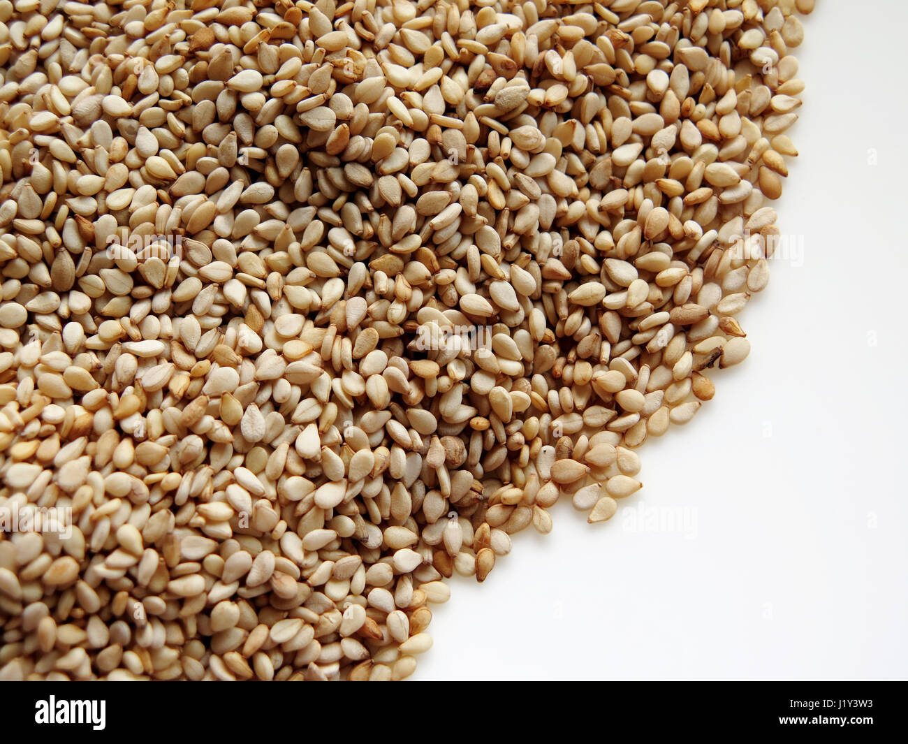 background of sesame seeds on a white background Stock Photo - Alamy