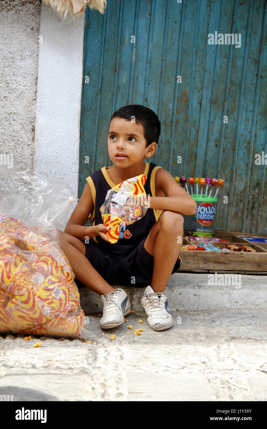 Morrocan boy selling sweets in a street in Chefchaouen, Morocco Stock ...