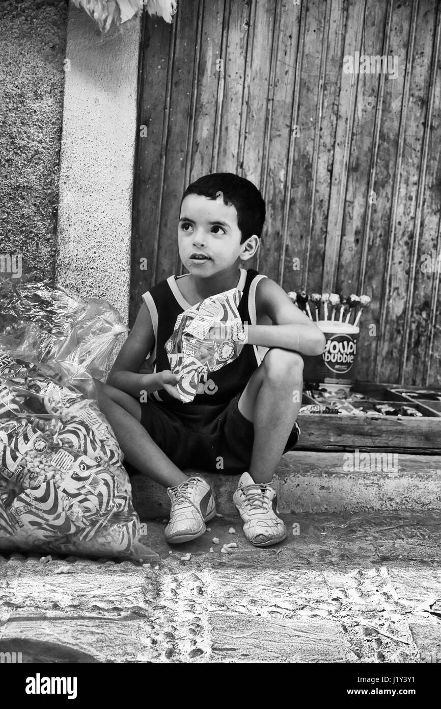 Morrocan boy selling sweets in a street in Chefchaouen, Morocco Stock ...