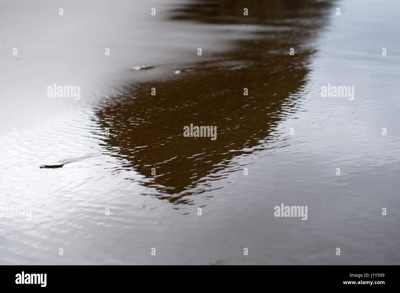 Reflection on water, with stones on water surface Stock Photo - Alamy
