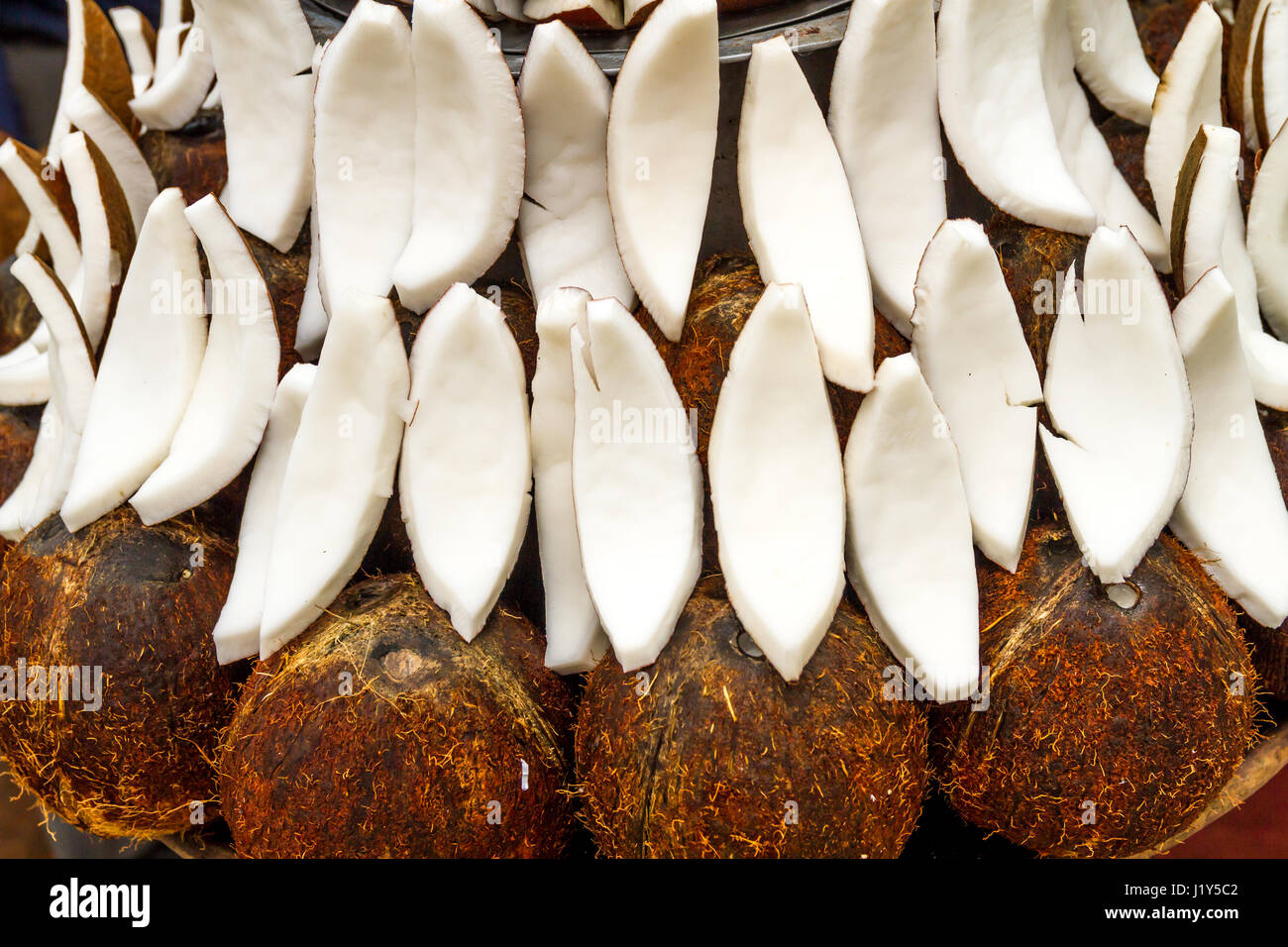Fresh matured whole brown coconut with sliced ones on sale in the ...