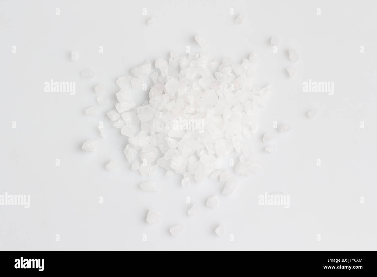 A scattering of sea salt on a white background Stock Photo - Alamy