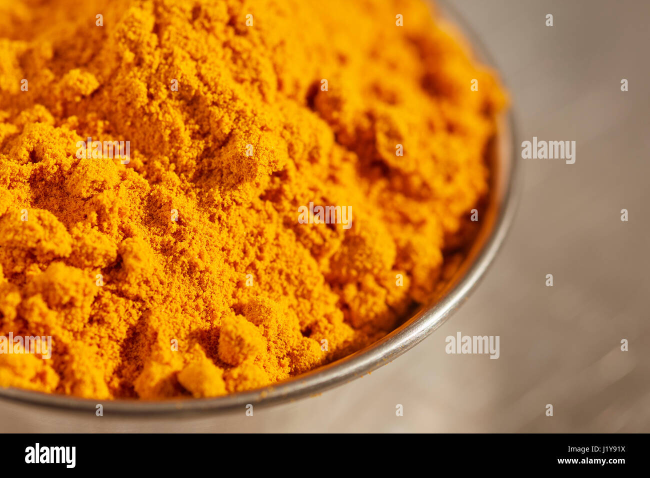 a small bowl of ground turmeric Stock Photo - Alamy