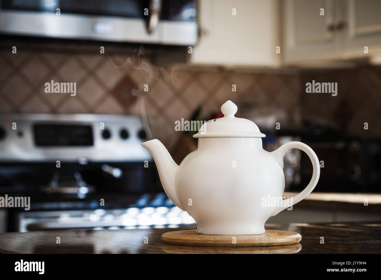 Old style teapot at modern kitchen interior Stock Photo - Alamy