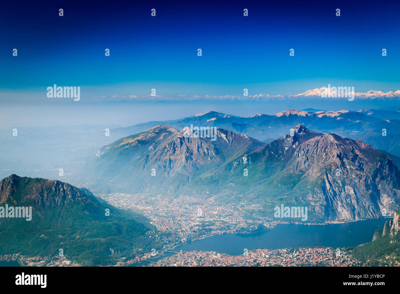 The lake of Como with the city of Lecco and the mountains behind in a ...