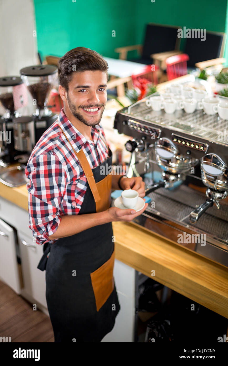 Smiling barista serving hot coffee a client Stock Photo - Alamy