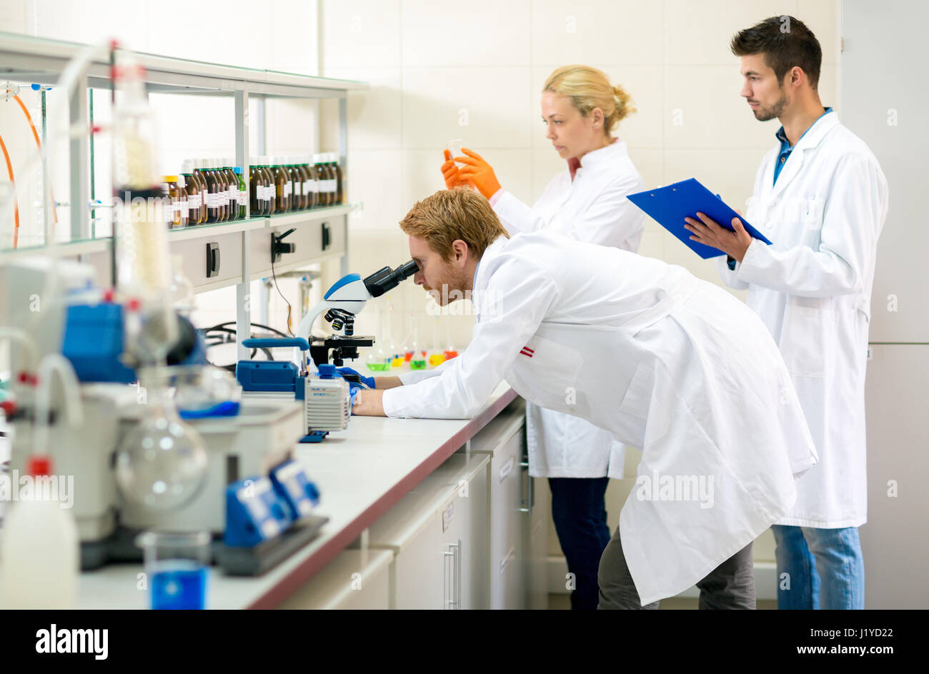 Teamwork of chemists working on analysis in lab Stock Photo - Alamy