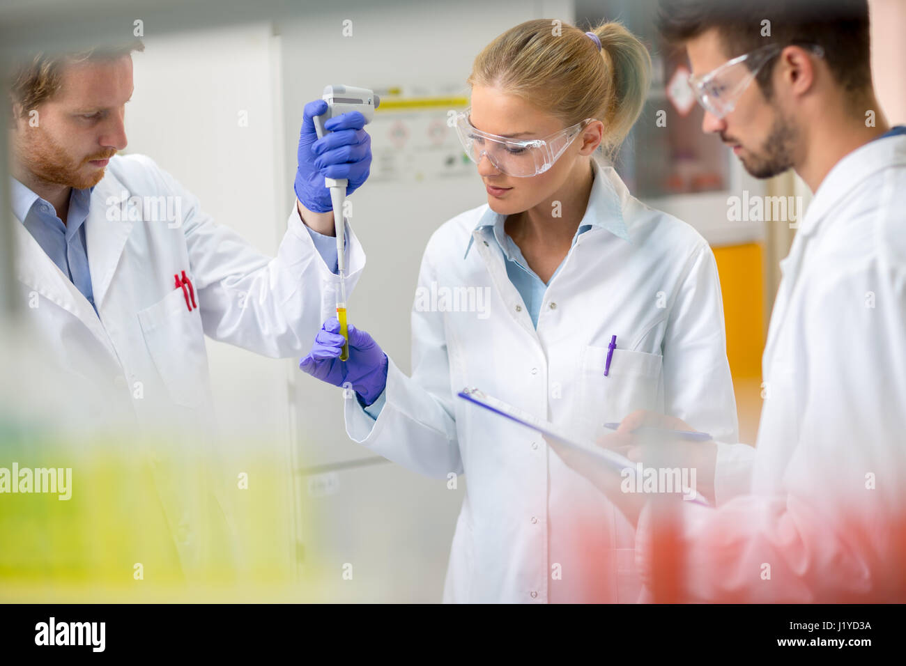 Expert team in chemical lab put sample of liquid in test pipette Stock ...
